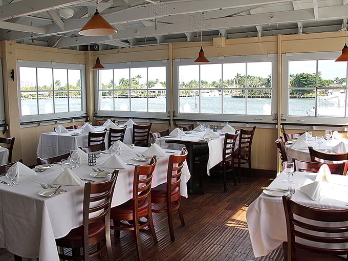 Dining with a view isn't just a perk here—it's practically mandatory. Those windows frame the Intracoastal like living paintings that change with every passing boat.