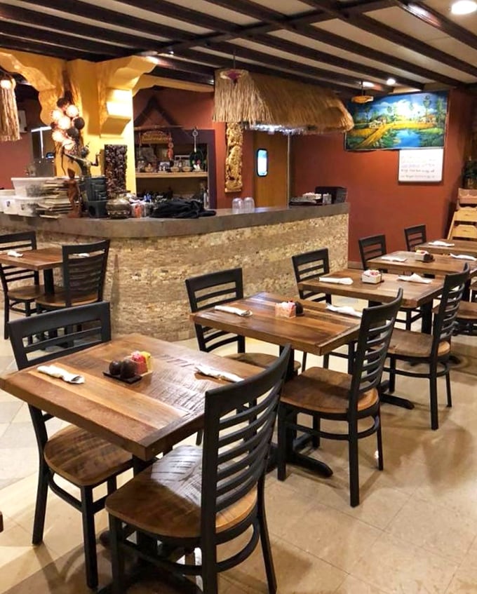 Wooden beams, warm lighting, and traditional Thai touches transform this Lima dining room into a cozy escape that's thousands of miles from Ohio.