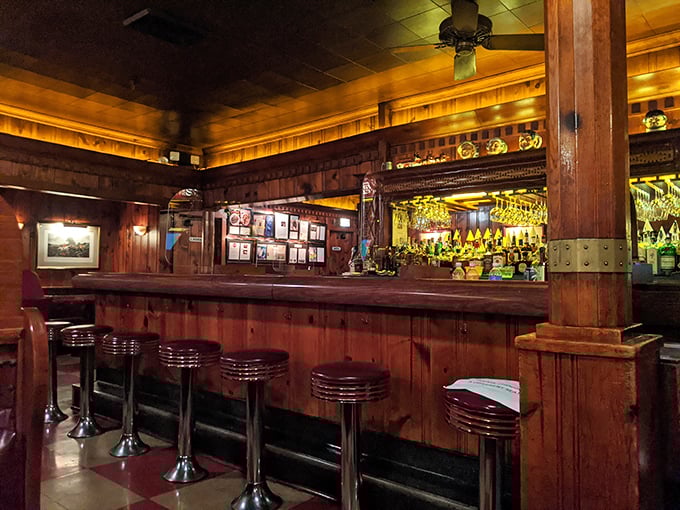 Step inside and time stands still – dark wood paneling, classic bar stools, and an atmosphere that whispers, "Put your phone away and enjoy your steak."
