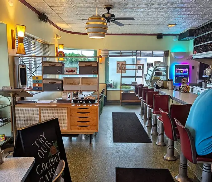 Step inside and suddenly you're in the diner of your dreams—pressed tin ceiling, vintage light fixtures, and those red counter stools practically begging for your company.