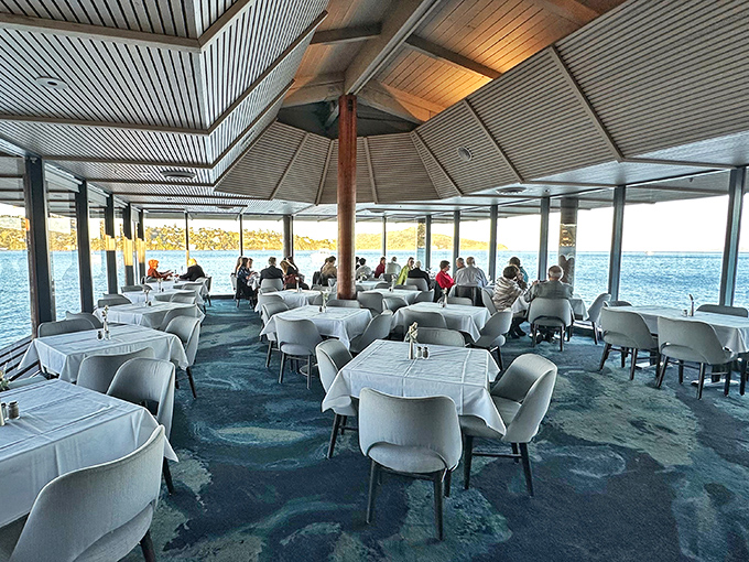 The dining room's panoramic windows transform every table into front-row seating for nature's daily performance of light dancing across San Francisco Bay.