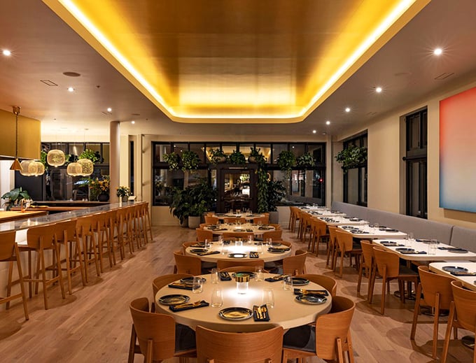 Golden light bathes the dining room in a warm Caribbean glow. The thoughtfully designed space balances sophistication with comfort—like a hug from a well-dressed friend.