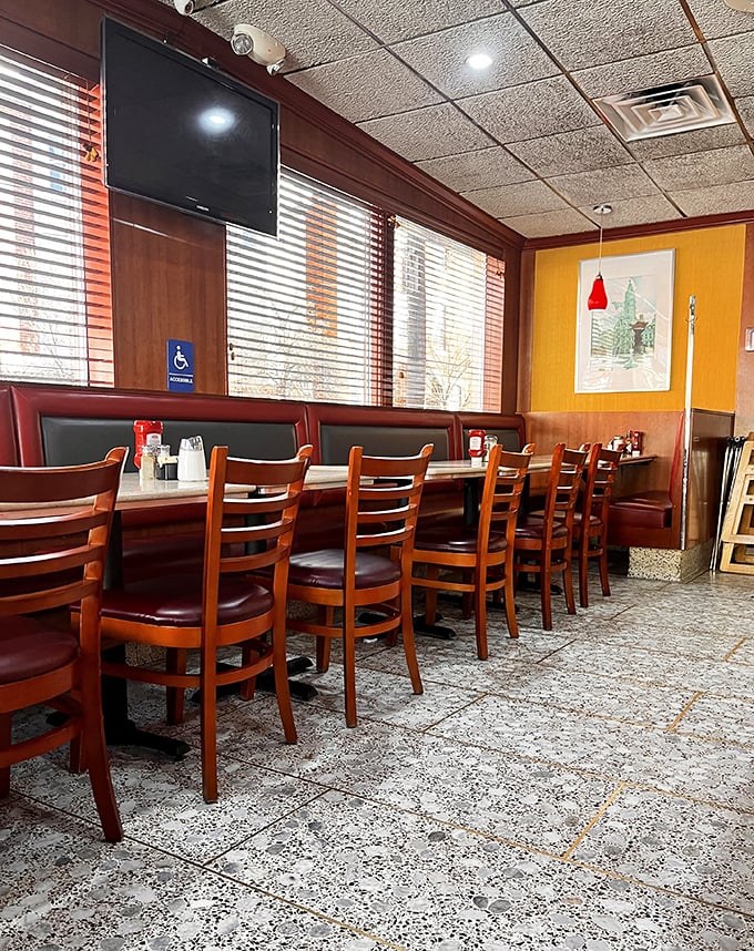 Classic diner booths with burgundy vinyl seating invite you to slide in, settle down, and prepare for the kind of meal that makes Monday mornings bearable.