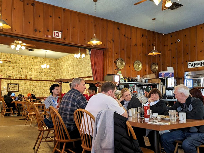 Wood-paneled walls and Windsor chairs create that perfect time-capsule diner vibe where conversations flow as freely as the coffee refills.