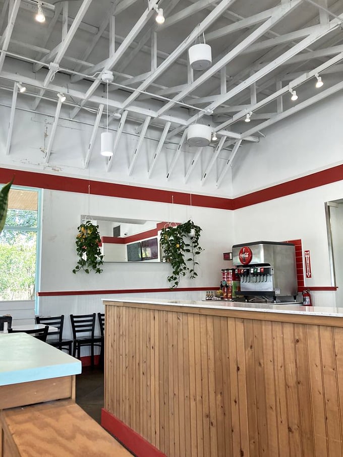 Exposed beams, clean lines, and that signature red stripe—Hugh-Baby's interior feels like a modern diner where comfort food gets the respect it deserves.