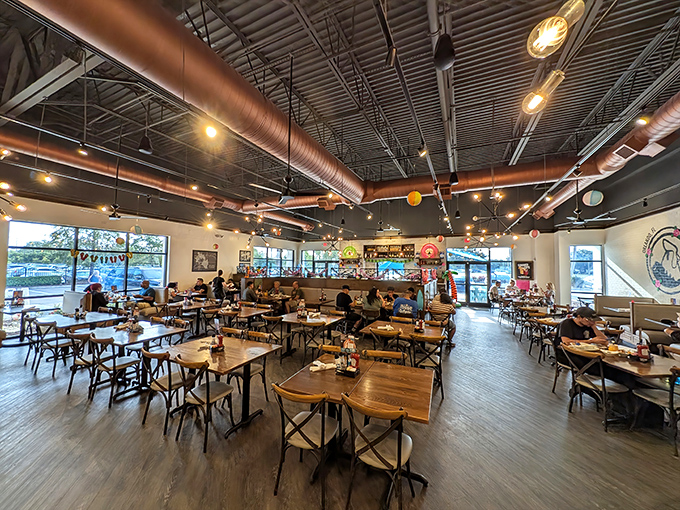 Industrial chic meets morning comfort in this airy space where breakfast dreams come true. The exposed ceiling adds character without pretension.