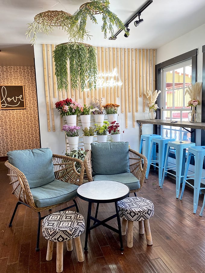 Indoor garden meets boho chic—hanging plants cascade from the ceiling while wicker chairs invite you to sink in and stay awhile.