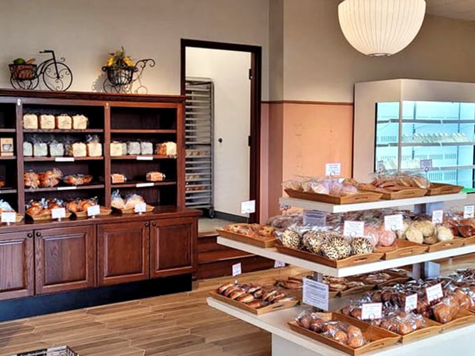 Wooden shelves lined with freshly baked treasures – this isn't just a bakery display, it's a museum of carbohydrate artistry.