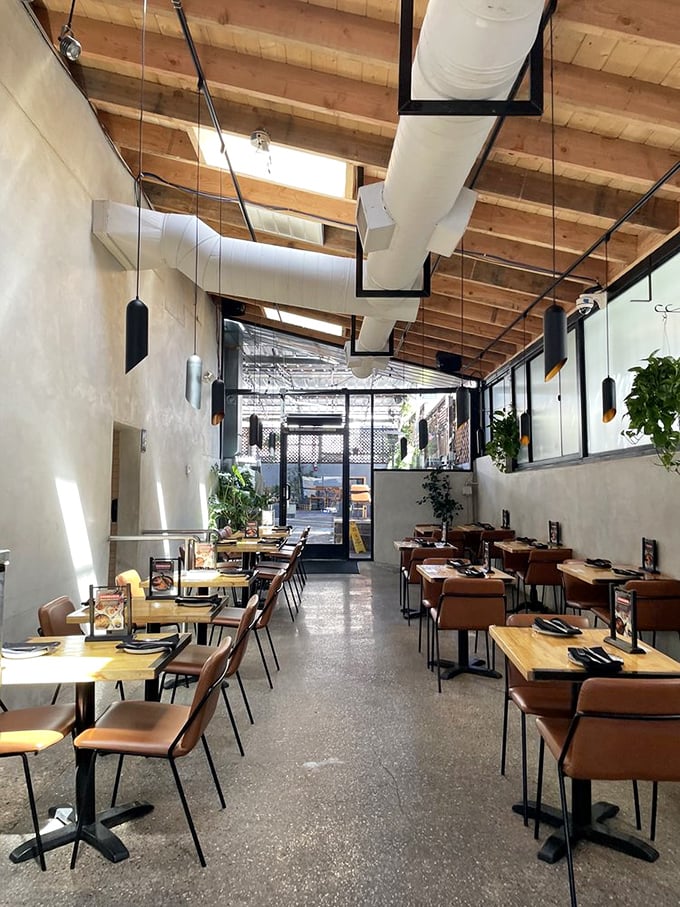 Warm wooden beams, simple furnishings, and natural light create a space where the food, not the decor, takes center stage.