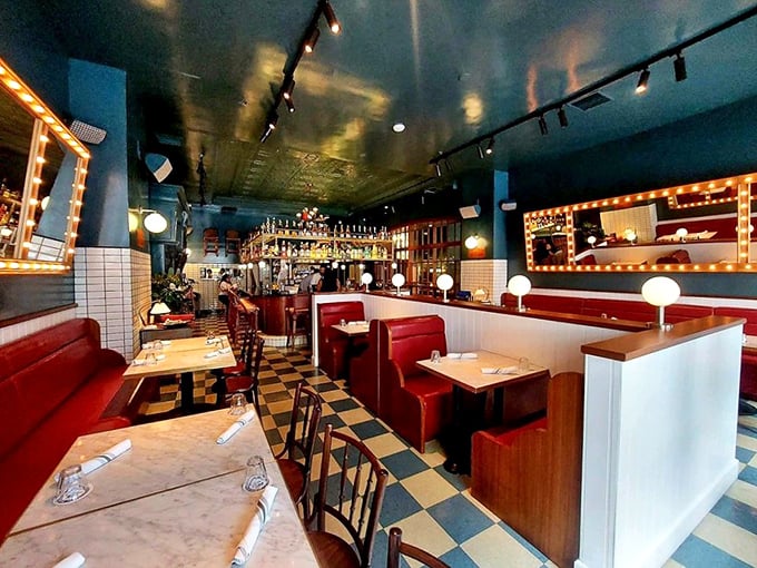 Blue ceilings, checkerboard floors, and red booths—it's like the French flag exploded into the coziest dining room this side of Montmartre.