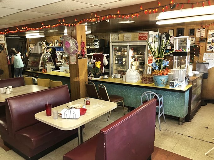 Inside, burgundy vinyl booths and festive string lights create that perfect time-capsule diner atmosphere where conversations flow as freely as the coffee.