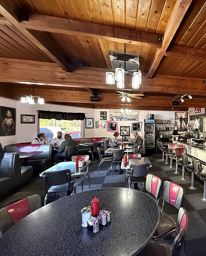 Wooden ceiling beams and mason jar lighting create that perfect "come as you are, leave fuller than you arrived" diner ambiance.