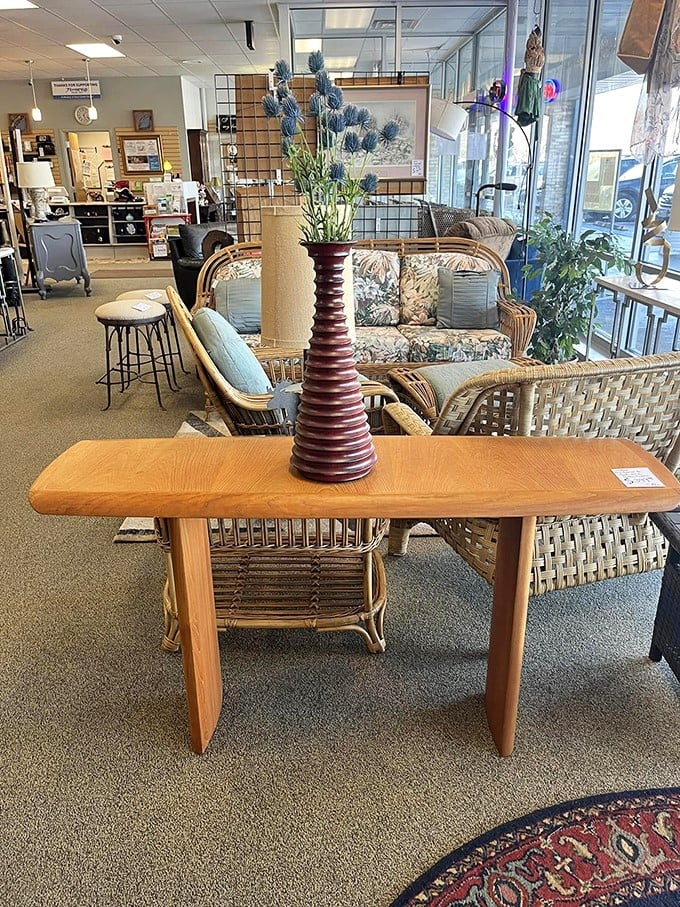 Mid-century wicker meets contemporary comfort in this furniture vignette. That spiral vase could easily be the star of a home design magazine spread.