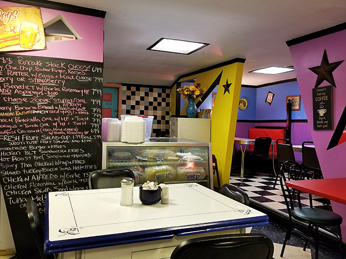 Step inside and the cosmic color scheme hits you—purple walls, yellow angles, and star decorations create a breakfast universe that's both nostalgic and totally unique.