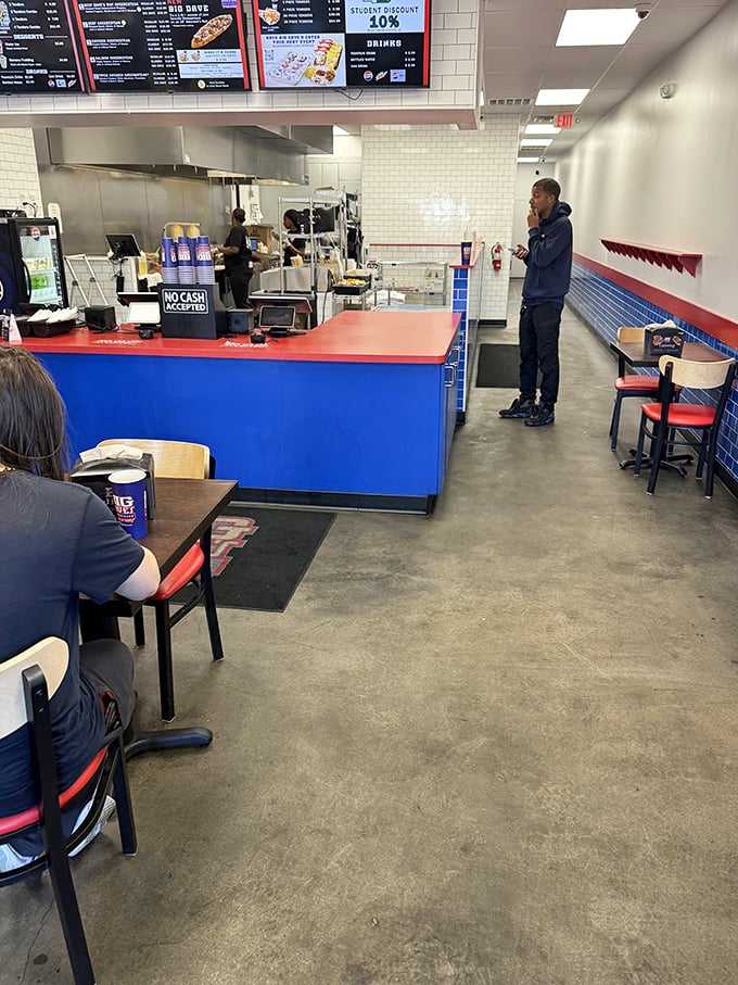 The red, white, and blue color scheme isn't just patriotic—it's a nod to Philly tradition. Simple seating means more room for what matters: sandwich craftsmanship.