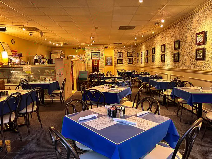 Blue tablecloths and vintage-inspired wallpaper create that perfect diner atmosphere—somewhere between your grandmother's dining room and breakfast heaven.