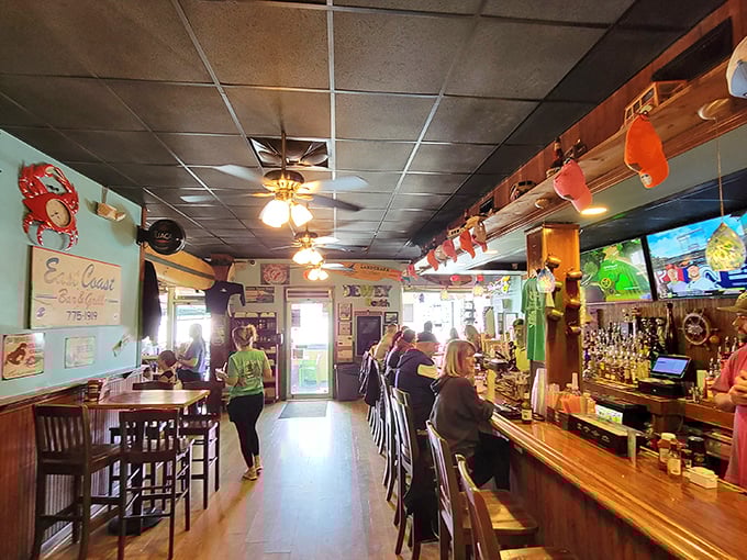 Inside, nautical charm meets beach-bar coziness. The ceiling fans spin lazily overhead as if they too are on vacation.