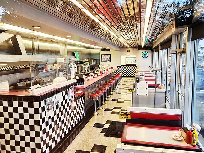 Classic Americana in every detail—red vinyl stools, checkered tiles, and a counter where strangers become friends over steaming mugs of coffee.