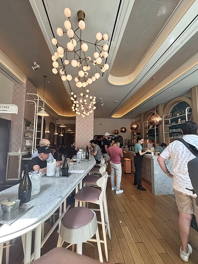 Step inside K'Far and you're transported to a world where elegant globe lighting, marble countertops, and warm wood create a space that feels both cosmopolitan and cozy.