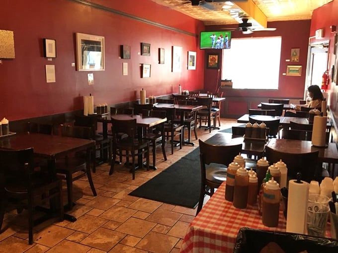 Red walls, wooden tables, and sauce bottles standing at attention – Mike's interior says "focus on the food, not the frills."