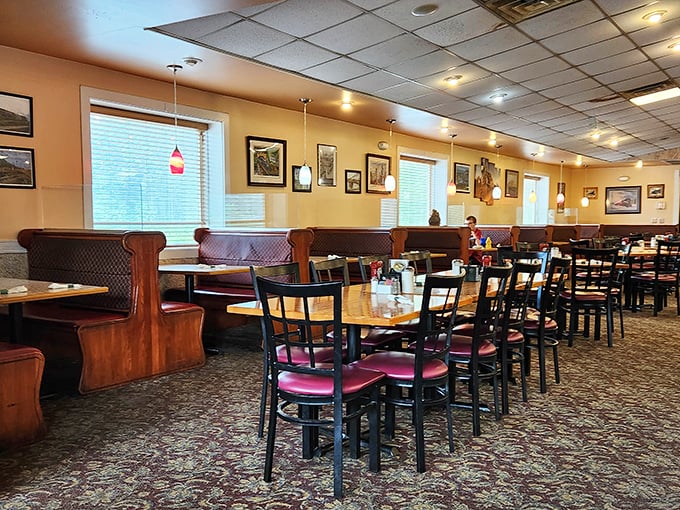 Classic diner ambiance with burgundy booths and simple tables – where conversations flow as freely as the coffee refills.