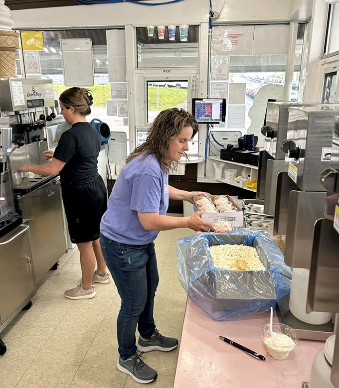 Behind the scenes, the magic happens in this compact kitchen where staff prepare each order with practiced efficiency and hometown pride.