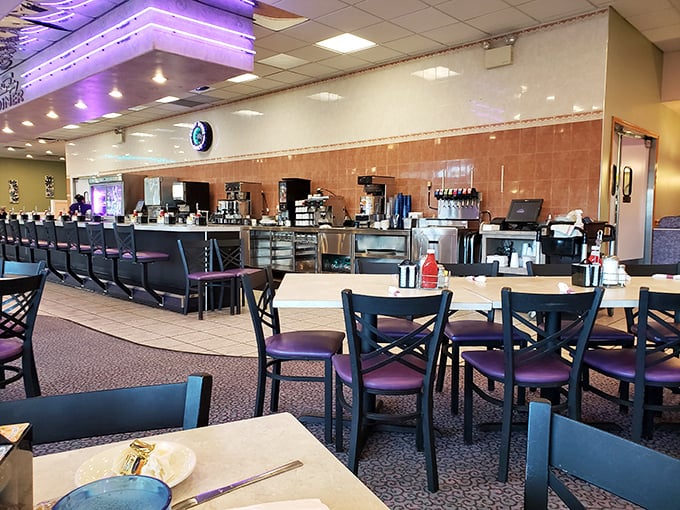 The spacious interior with its signature purple chairs offers that perfect blend of cleanliness and coziness—diner perfection without a hint of pretension.