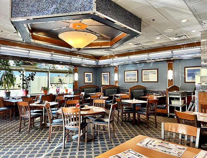 Blue walls, wooden chairs, and that unmistakable hexagonal ceiling fixture – diner design that whispers, "Settle in, we've got all day."