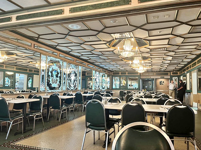 Those mirrors aren't just decor – they're multiplying your dining joy into infinity, chandelier glamour included.