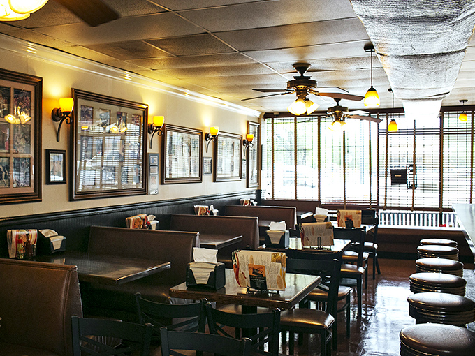 Step inside and you're transported to a simpler time – warm wood paneling, cozy booths, and ceiling fans that have witnessed decades of satisfied sighs.