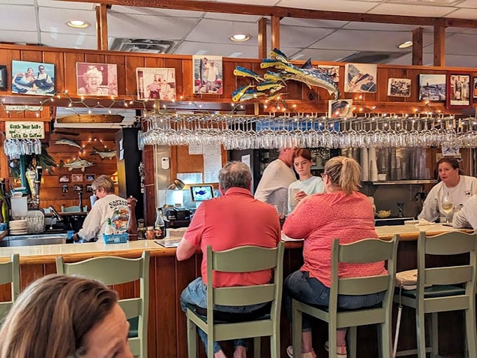 The counter seating offers front-row tickets to the culinary show, where hanging glassware sparkles like ocean treasures.
