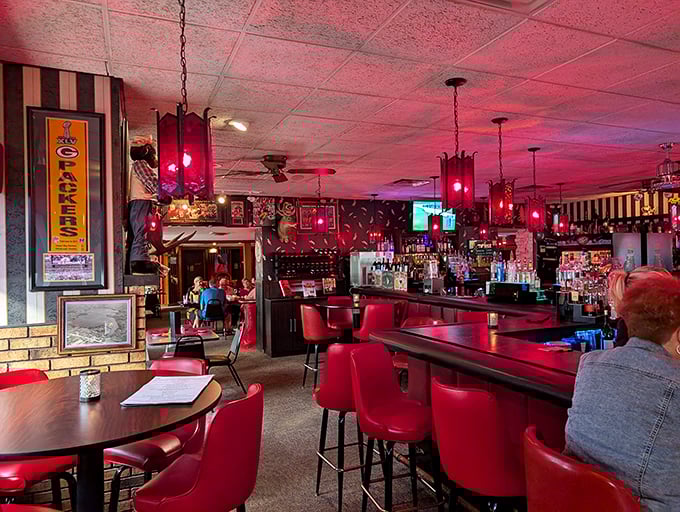 Step into the crimson glow of supper club perfection. Those red leather chairs aren't just seating – they're time machines to when dining was an event.