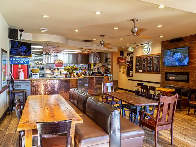 Rustic wooden tables meet copper-topped counters in this cozy interior where comfort food dreams come true.