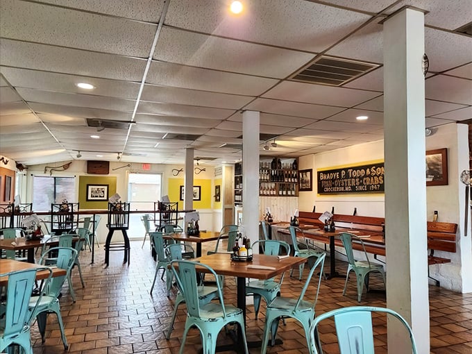 Inside, aqua metal chairs and wooden tables create a casual maritime vibe, while the "Ruark & Todd & Son" sign hints at the establishment's deep local roots.
