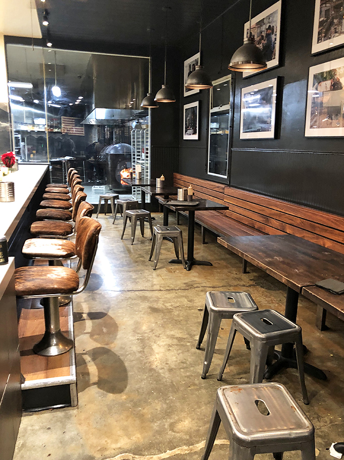 Industrial chic meets barbecue functionality inside Horn Barbecue, where leather-seated stools offer front-row seats to the meat-slicing spectacle.