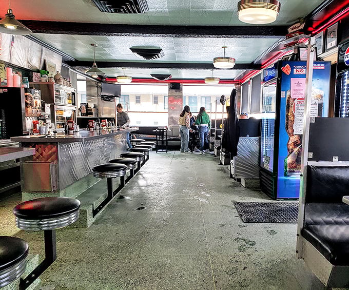 Step inside and time stands still—black stools lined up at the counter like loyal soldiers, ready for the next hungry patron.