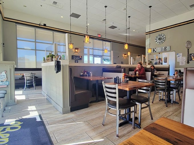 Inside Benny's, pendant lights cast a warm glow over wooden tables where breakfast dreams come true and diet plans go to die.