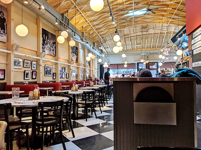 Sunshine streams through the windows, illuminating a classic deli interior where checkered floors and vintage photos tell stories of meals past.