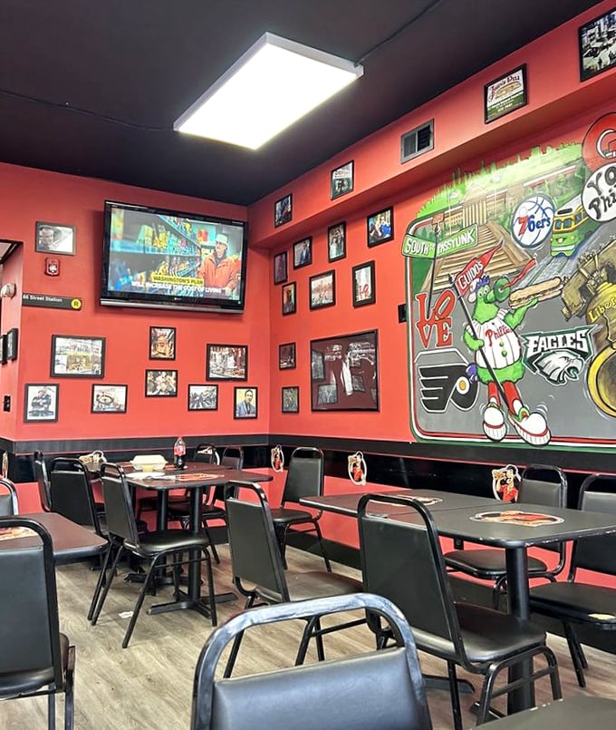 Inside, vibrant red walls showcase Philadelphia sports pride, with the Phillie Phanatic mural watching over diners like a green, fuzzy guardian angel.