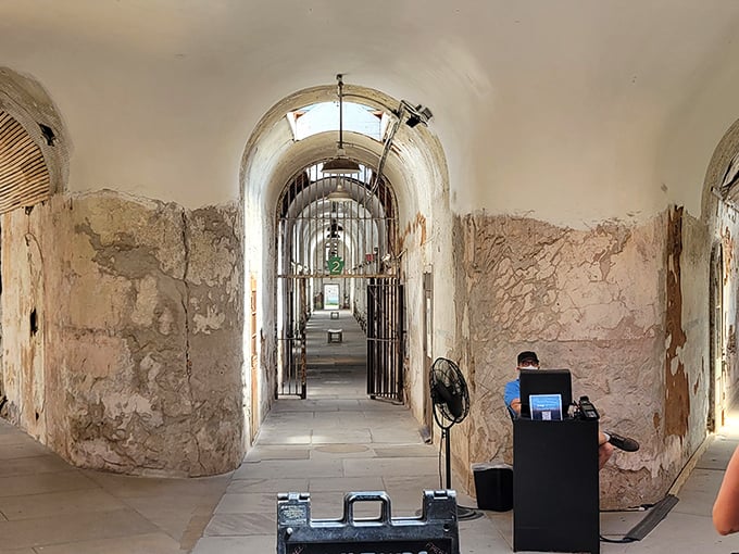 The haunting beauty of prison architecture on display—arched ceilings and crumbling walls create an atmosphere that's equal parts historical treasure and horror movie set.