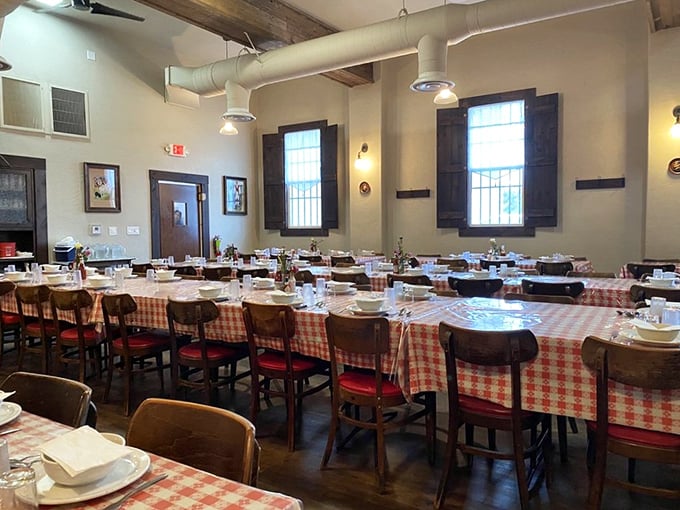 Red-and-white checkered tablecloths set the stage for communal dining magic, where strangers become friends united by the universal language of deliciousness.