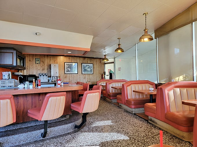 Salmon-colored booths and wood paneling create a time capsule where conversations flow as freely as the coffee refills. 