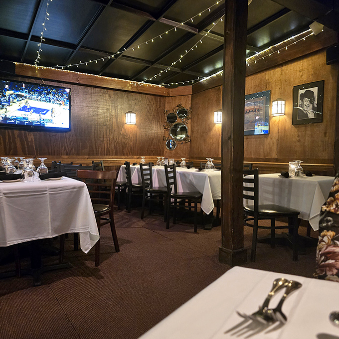Wood-paneled walls, white tablecloths, and twinkling string lights create that perfect steakhouse ambiance where memories are made and diets are gloriously forgotten.