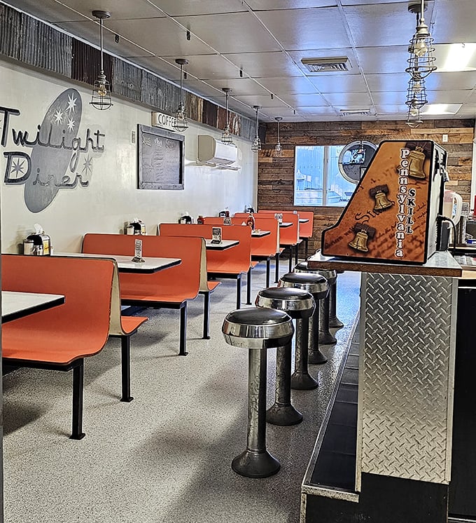 Classic orange booths and chrome stools create that perfect diner atmosphere where comfort food and conversation flow equally freely.