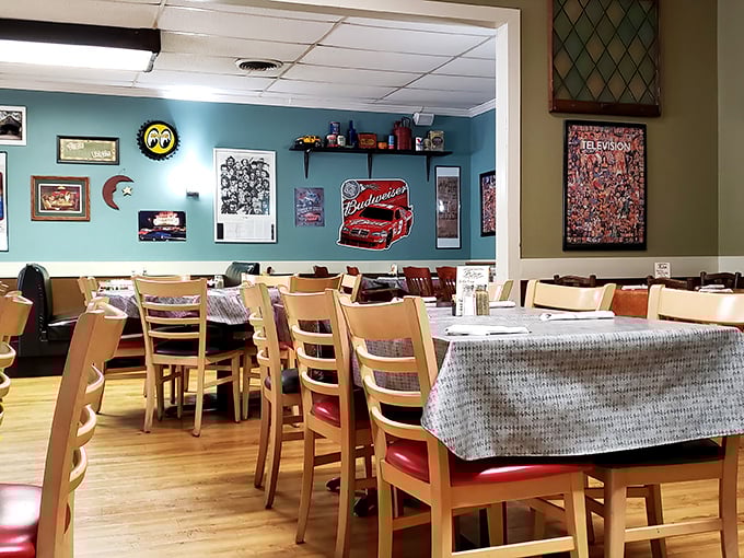 Blue walls adorned with racing memorabilia and local art create that perfect "everybody knows your name" vibe that chain restaurants spend millions trying to replicate.