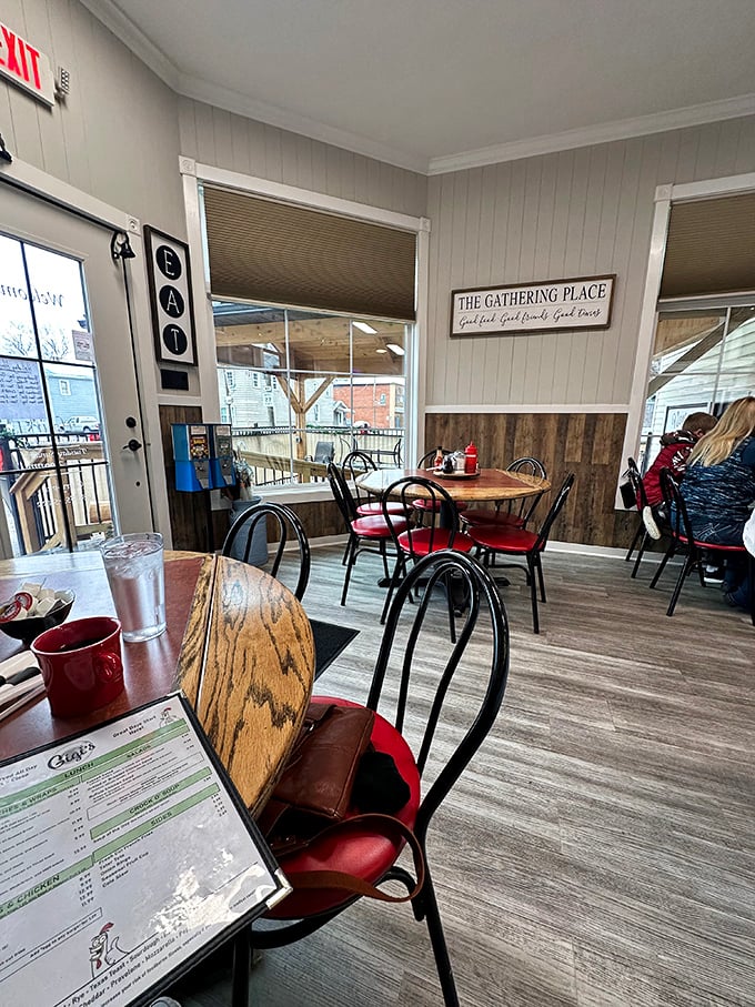 Inside Gigi's, the "Gathering Place" sign tells you everything you need to know. Red chairs and wooden tables create the perfect backdrop for morning conversations.