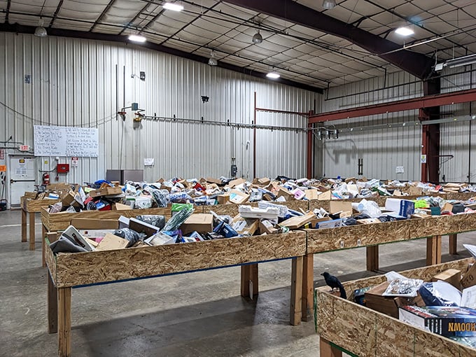 Wooden bins stretch across the concrete floor like feeding troughs for bargain-hungry shoppers. Dive in and discover!