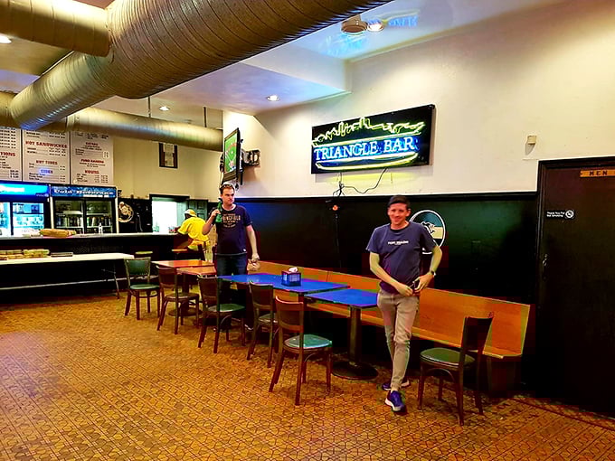 Simple wooden booths, classic tile floors, and that neon glow—this isn't Instagram bait, it's sandwich paradise in its natural habitat.