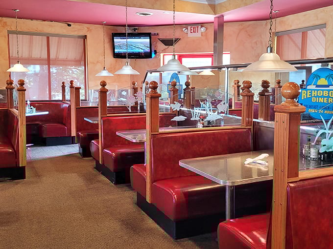 Classic red booths and wooden dividers create that perfect diner atmosphere where memories are made between coffee refills.