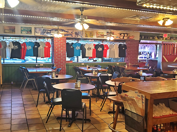 Inside, the no-frills dining room feels like a time capsule where conversations flow as freely as the coffee, and the t-shirts on display have become local souvenirs.
